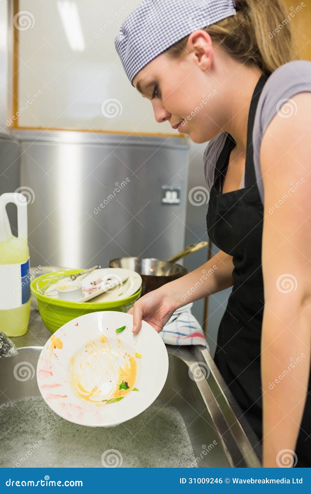Unsmiling Woman Washing a Plate Stock Photo - Image of chef, food: 31009246