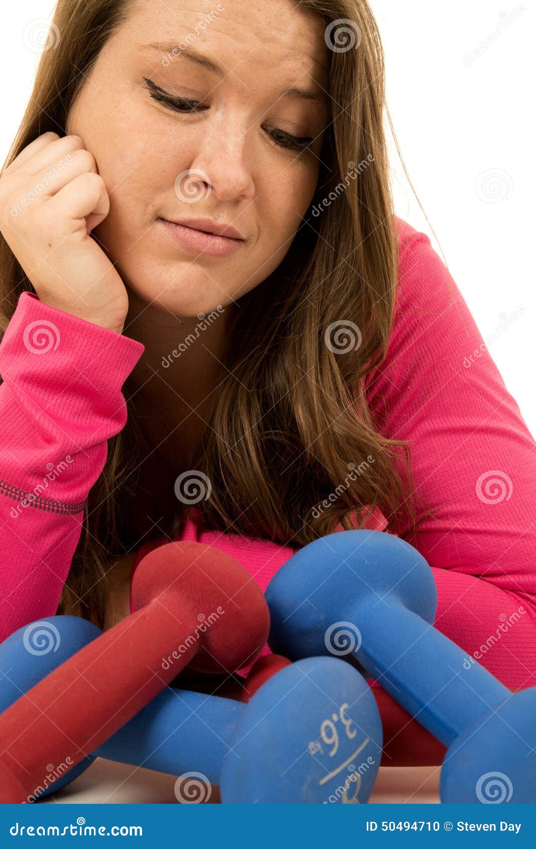 Unsure Model Looking at Pile of Hand Weights Stock Photo - Image of ...