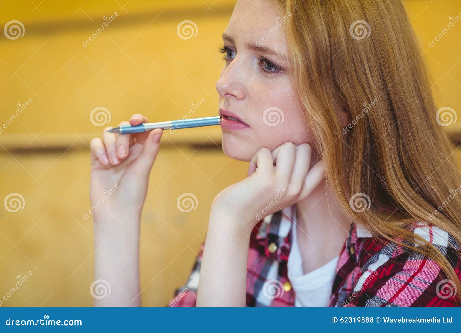 Unsure Student Holding Pen during Class Stock Photo - Image of room ...