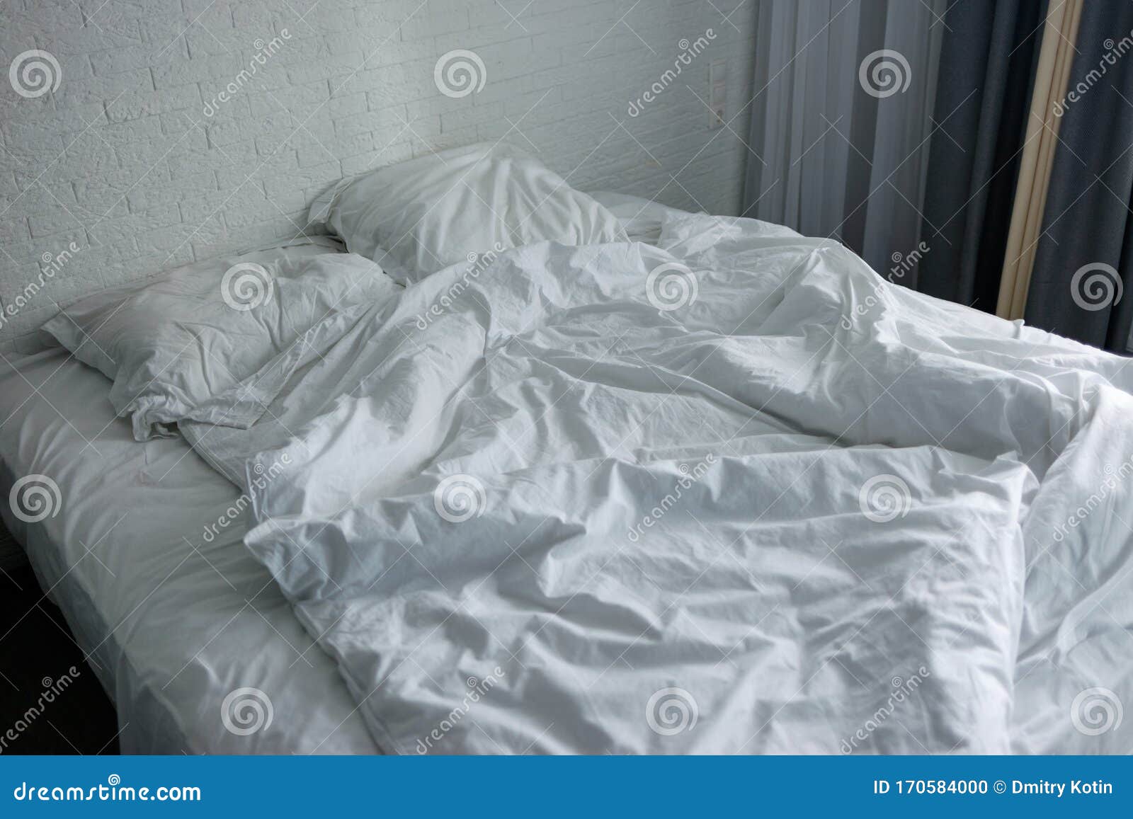Untidy Crumpled Bed with White Bedclothes. Stock Photo - Image of ...