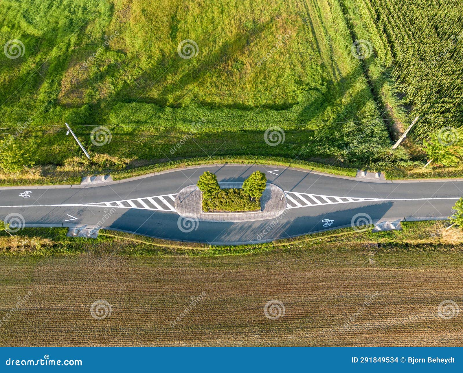 Unusual Split: Countryside Road Curiously Divided Amidst Fields Stock ...