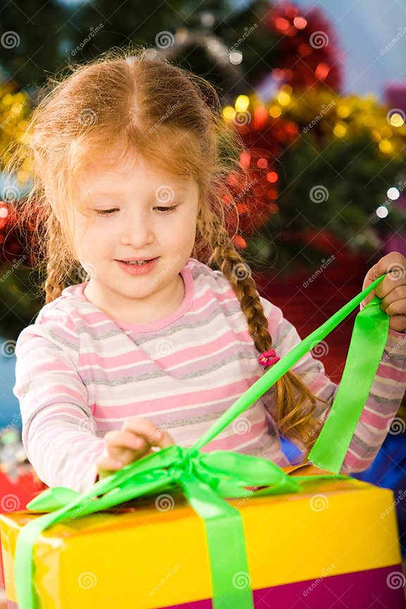 Unwrapping present stock image. Image of positive, festive - 7218421