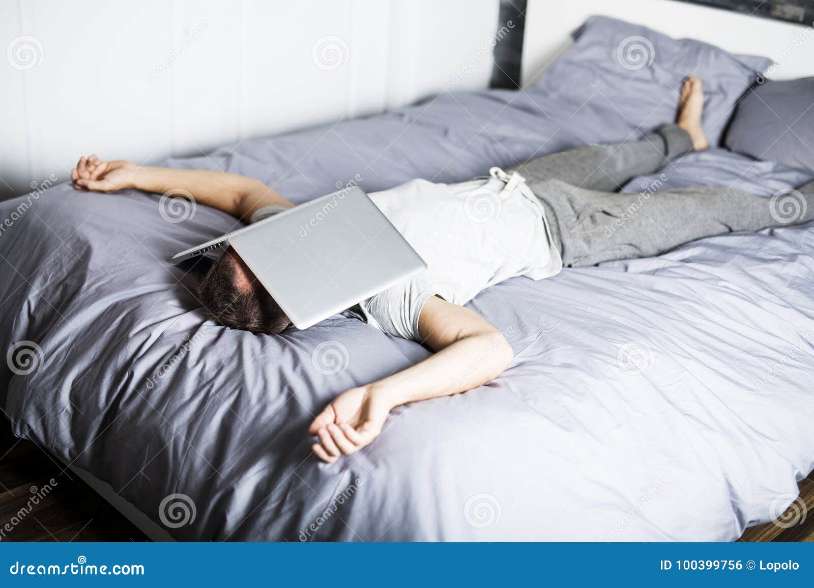 Uomo Che Dorme Sopra Il Computer Portatile a Letto Fotografia Stock ...