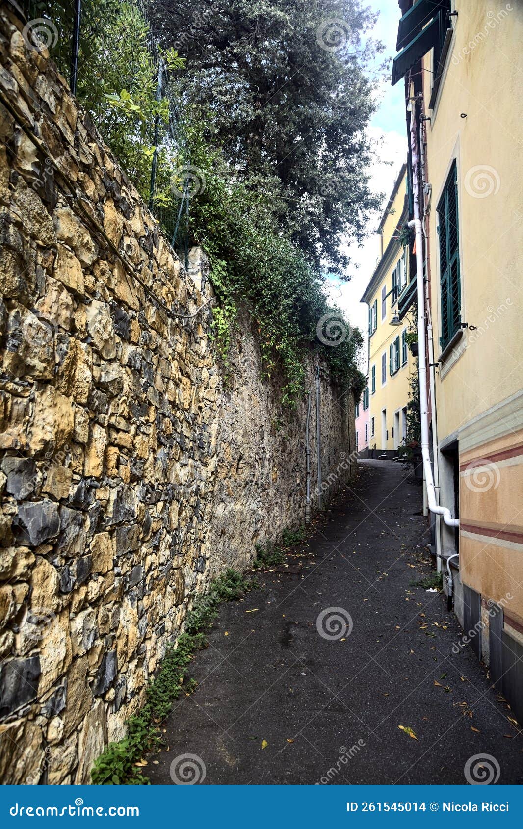Uphill Alley between a Stone Wall and a Building Stock Photo - Image of ...