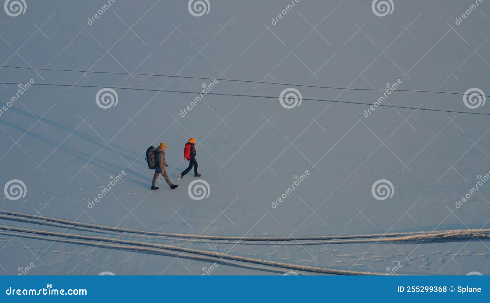 The Upper View on Two Tourists Trekking through the Icy Field. Stock ...