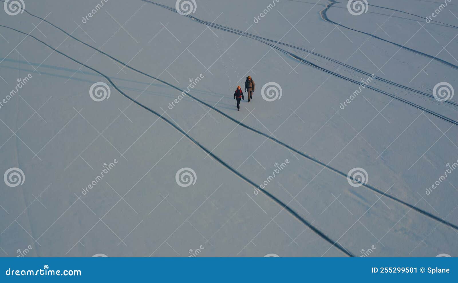 The Upper View on Two Tourists Trekking through the Icy Field. Stock ...