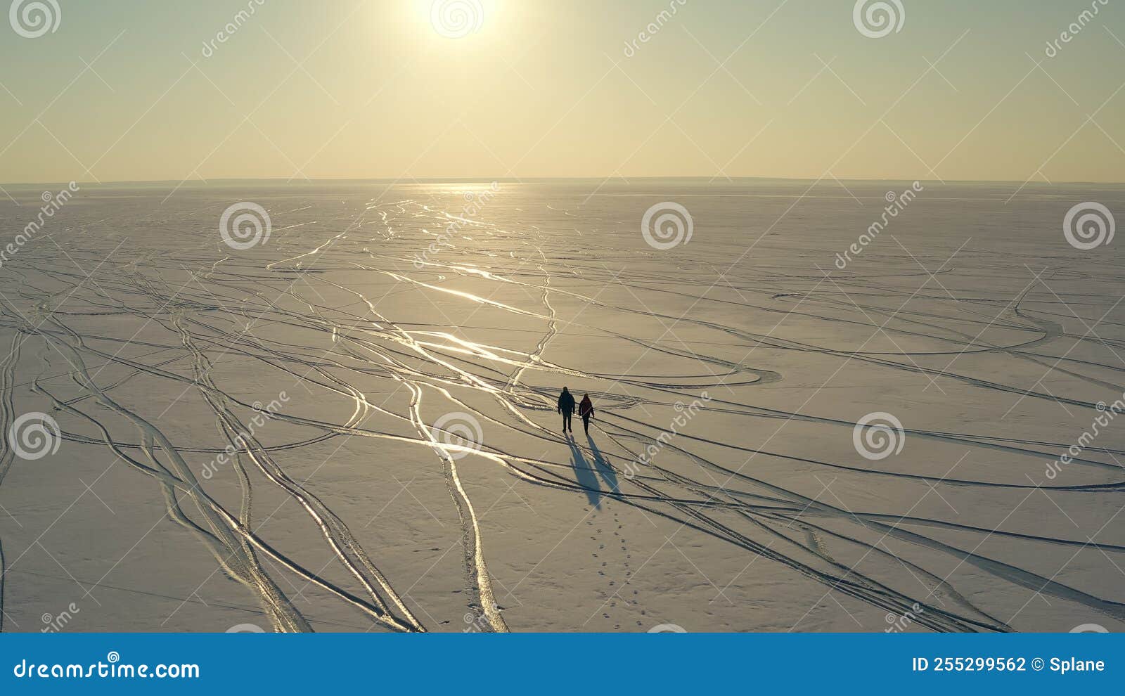 The Upper View on Two Tourists Trekking through the Icy Field. Stock ...