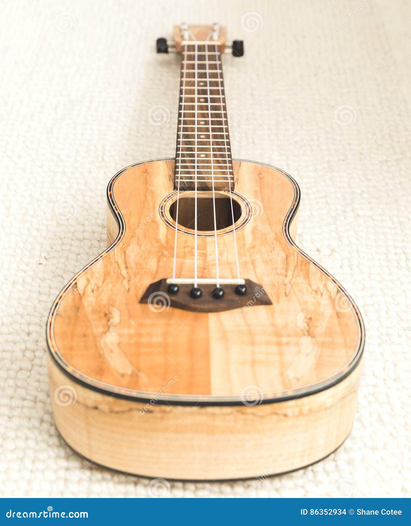 Upscale Ukulele with Woodgrain Finish Stock Photo - Image of instrument ...
