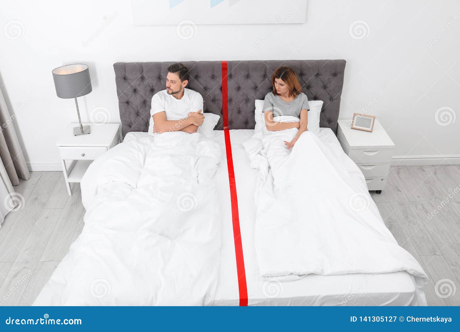 Upset Couple with Relationship Problems Lying Separately in Bed Stock ...