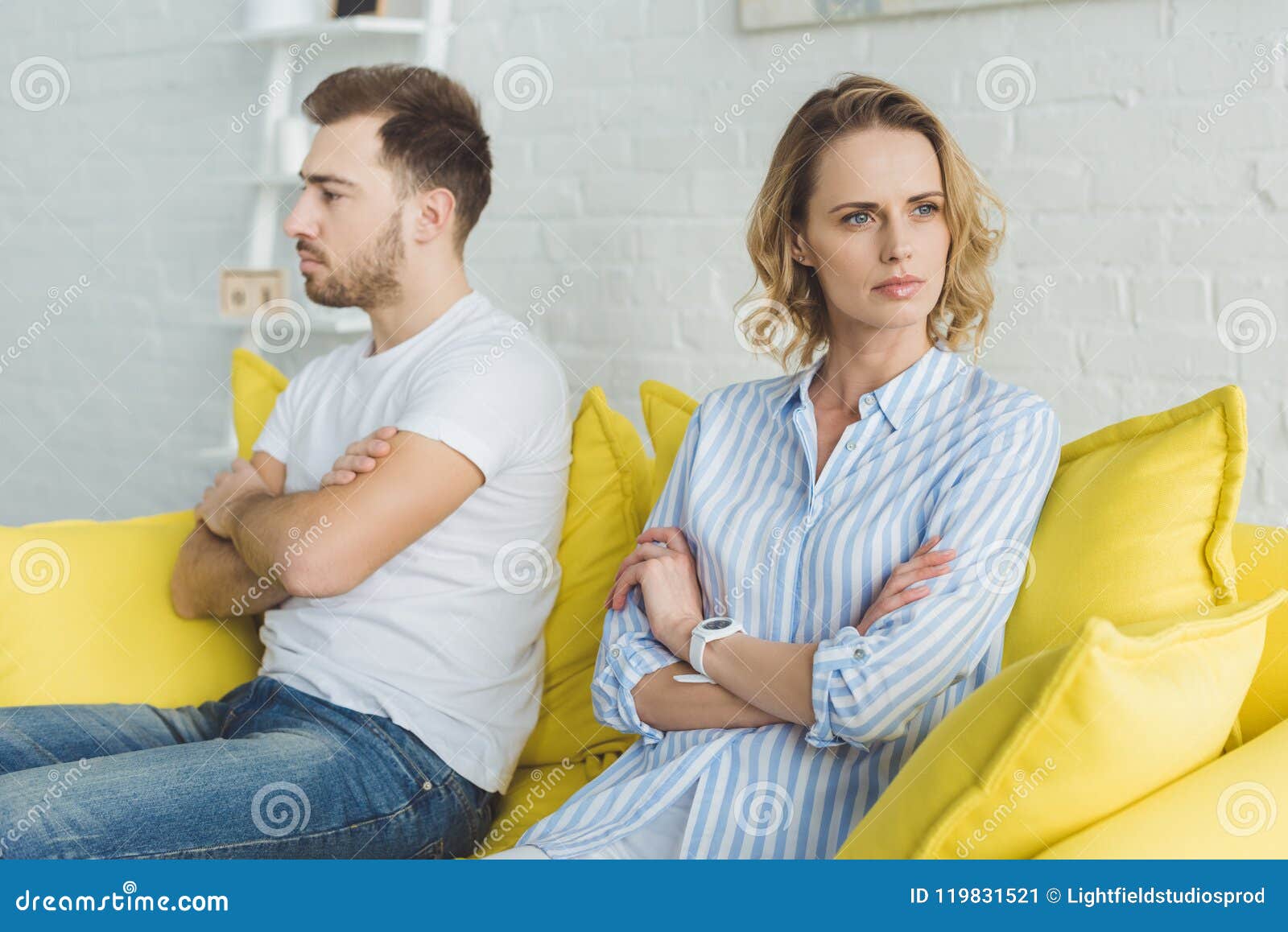 Upset Couple Sitting on Yellow Couch after Stock Image - Image of ...