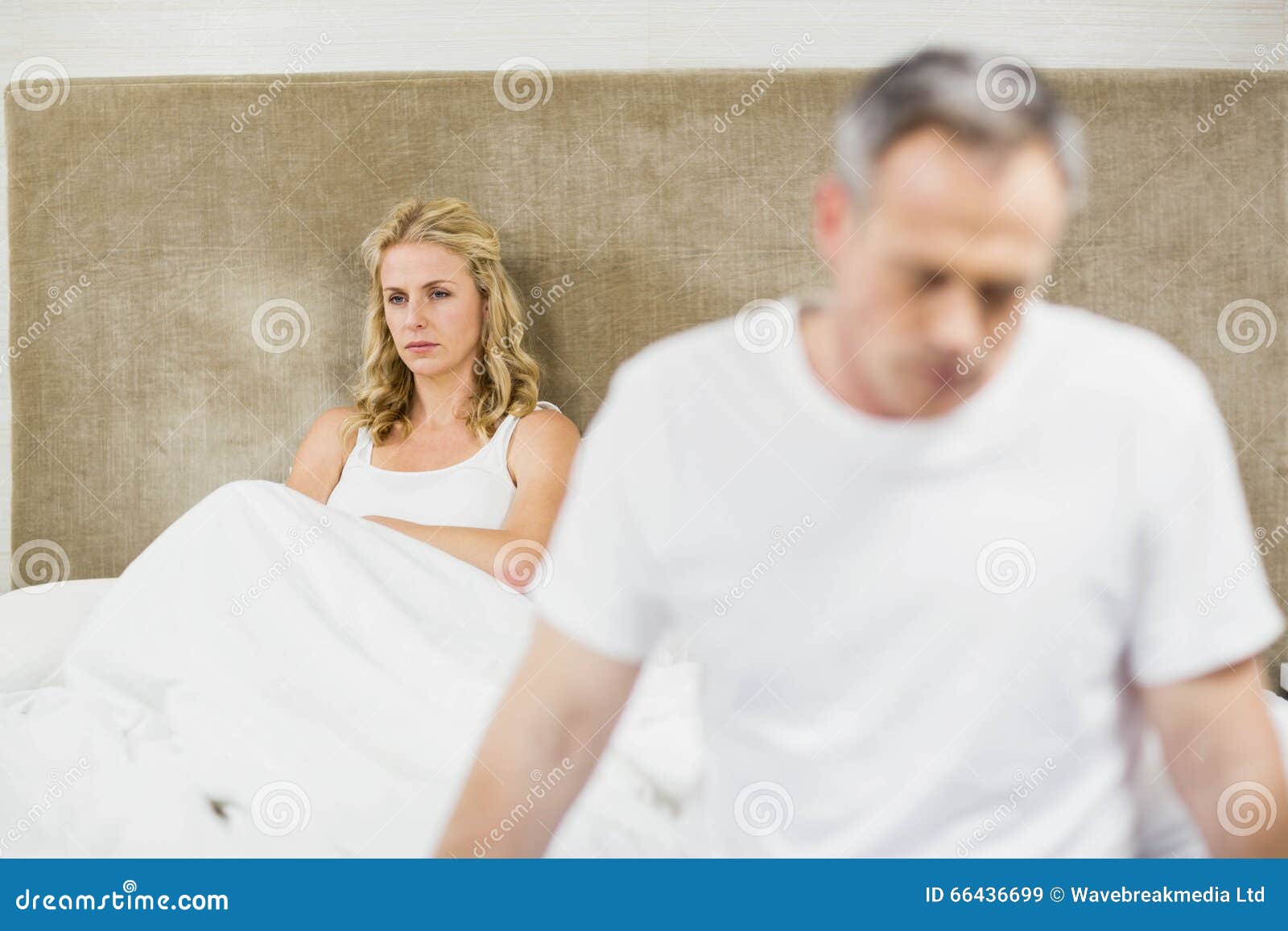 Couple Sulking Each Other Sitting Back To Back On Bed Royalty-Free ...
