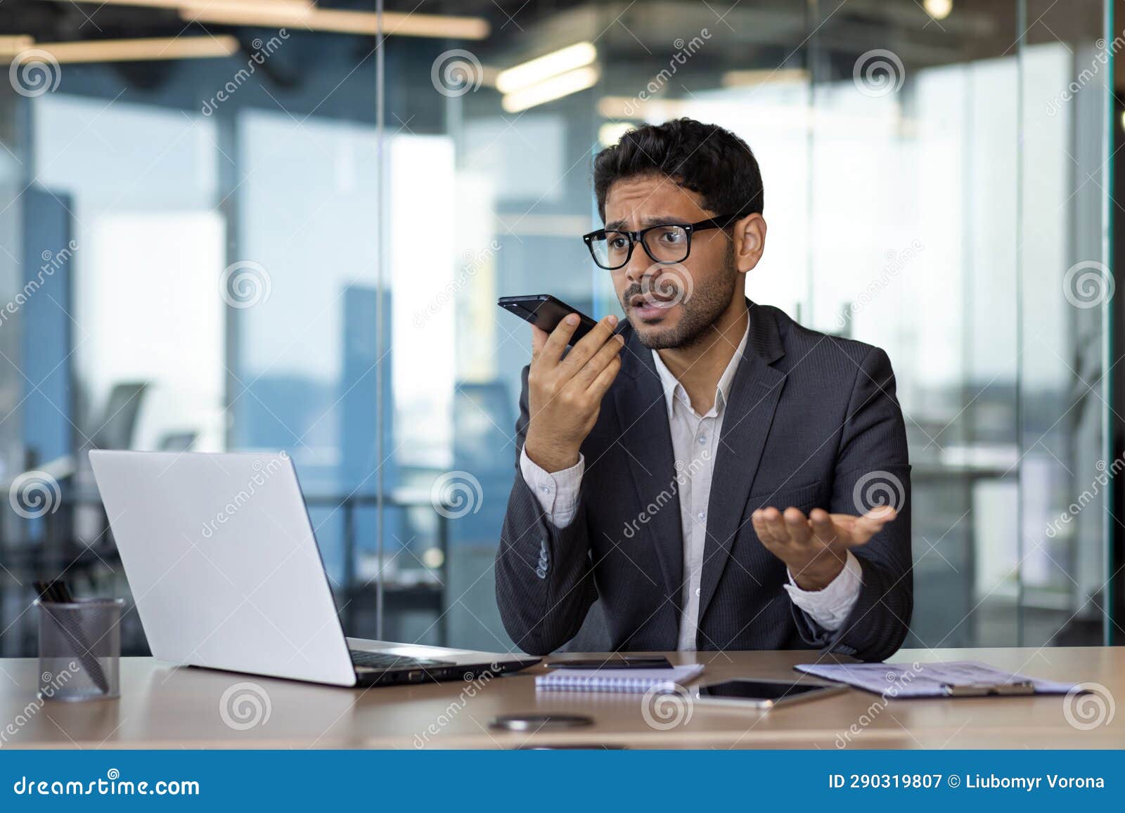 Upset and Disappointed Hispanic Businessman Recording Audio Message ... Upset and Disappointed Hispanic Businessman Recording Audio Message ...
