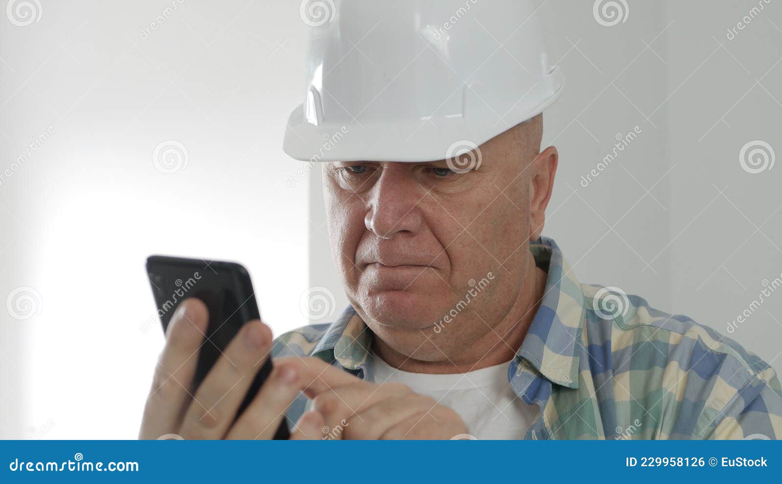 Upset Engineer Texting on Mobile Phone. Constructor Sending and ...