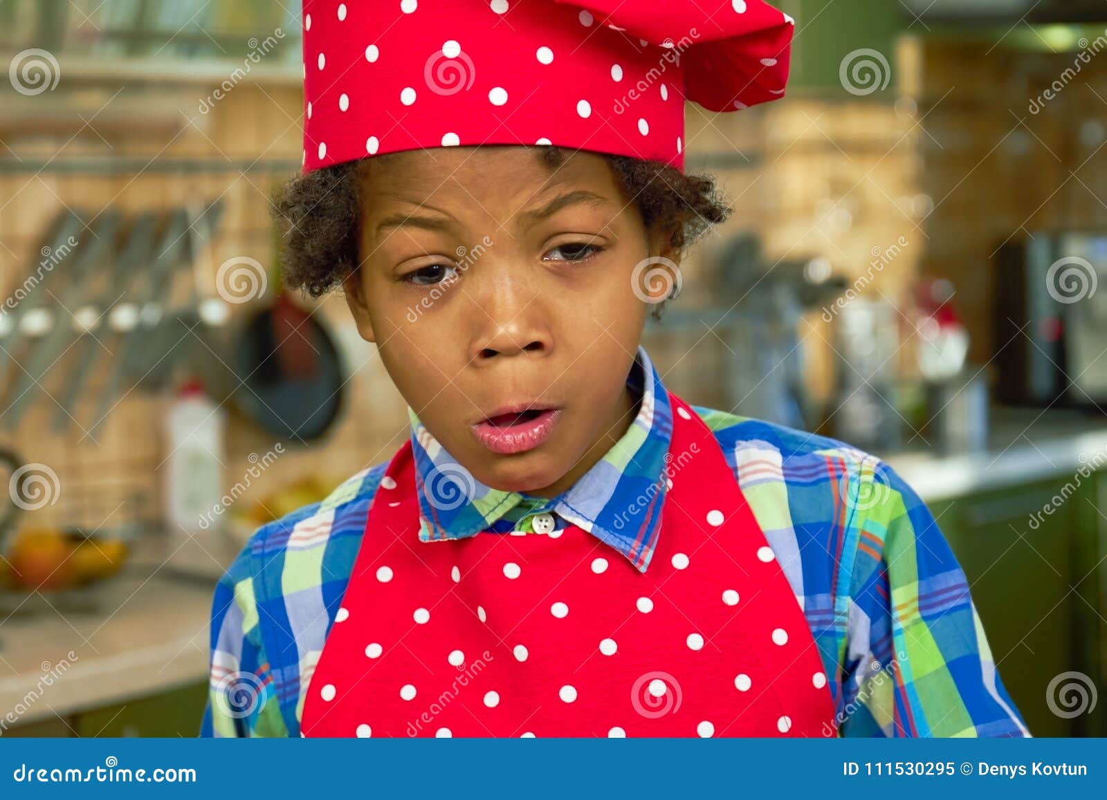 Upset kid in chef uniform. stock image. Image of emotion - 111530295