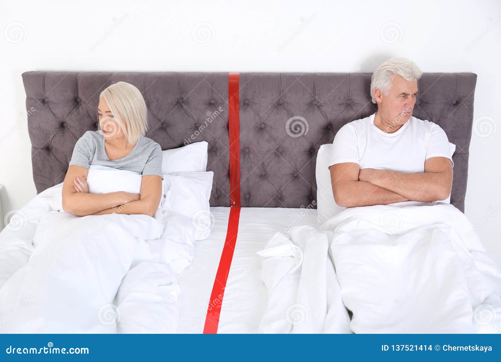 Upset Mature Couple with Relationship Problems Lying Separately in Bed ...