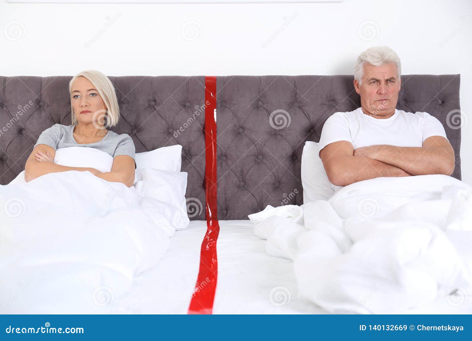 Upset Mature Couple with Relationship Problems Lying Separately in Bed ...