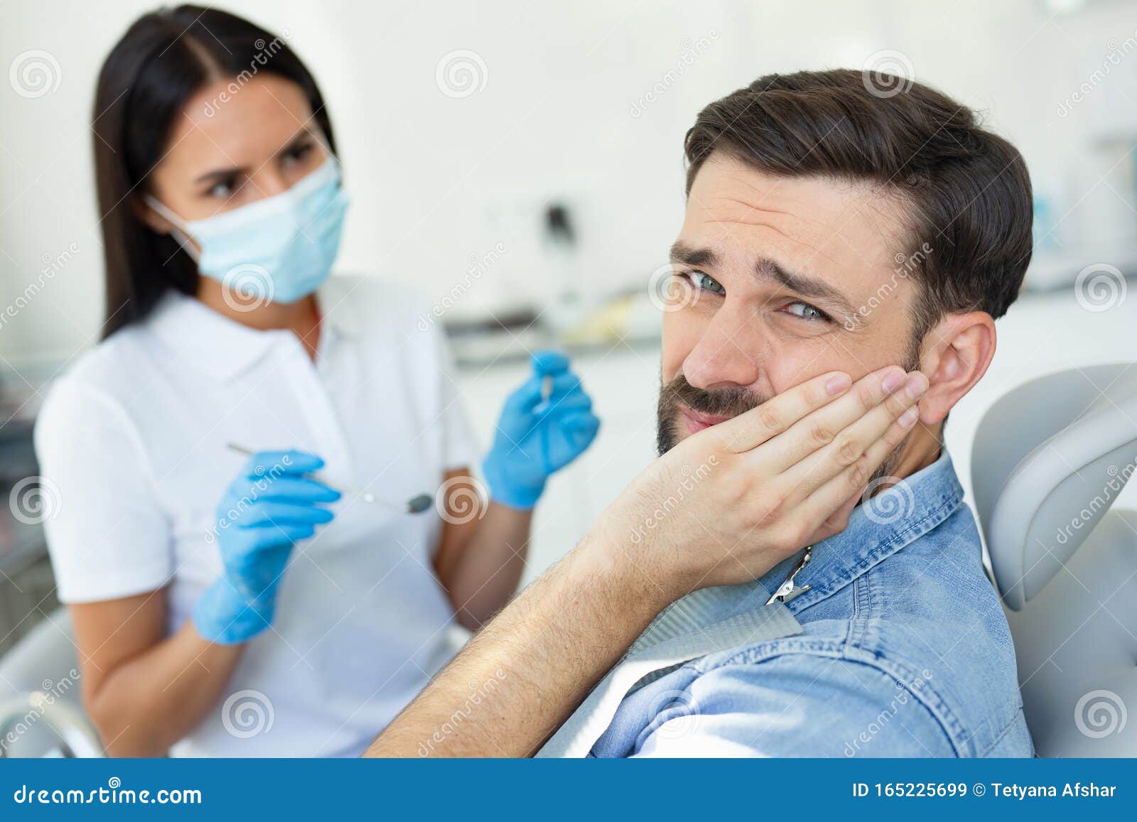 Upset Patient Touching Face while Having Toothache Near Dentist Stock ...