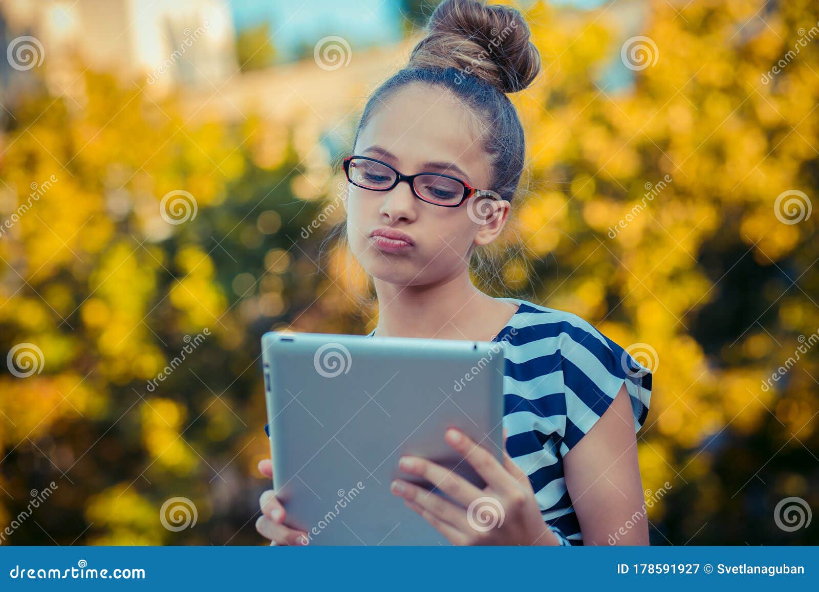 Upset Sad Skeptical Unhappy Serious Girl Using Mobile Pad Computer ... Upset Sad Skeptical Unhappy Serious Girl Using Mobile Pad Computer ...