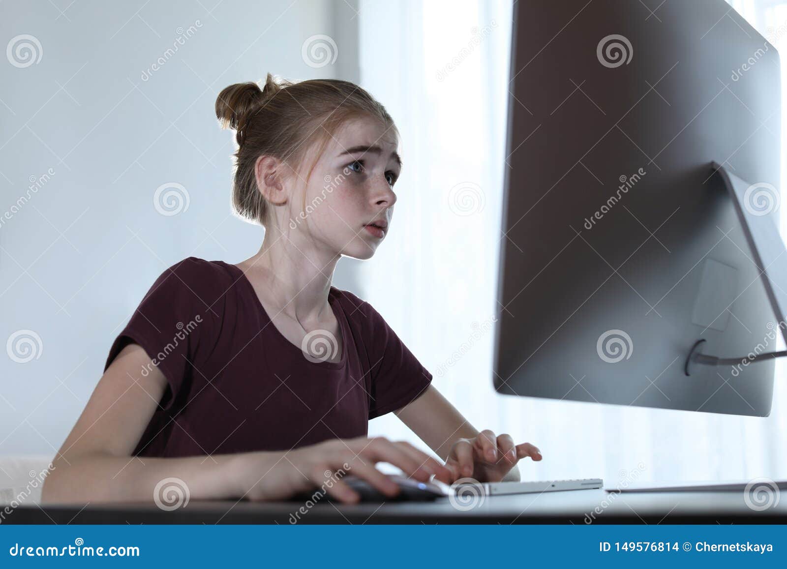 Upset Teenage Girl Using Computer at Table. Danger of Internet Stock ...