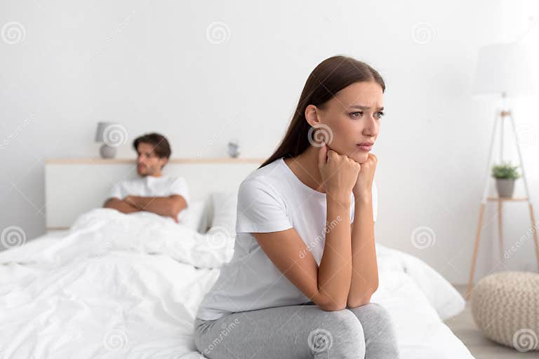 Upset Unhappy Offended Angry Millennial European Wife Sitting On Bed