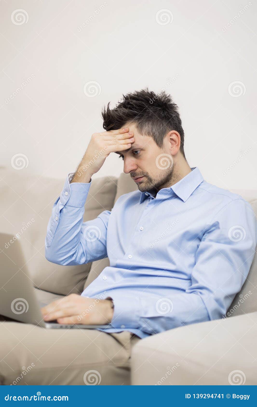 Upset and Worried Young Businessman Sitting and Working at Laptop Stock ... Upset and Worried Young Businessman Sitting and Working at Laptop Stock ...
