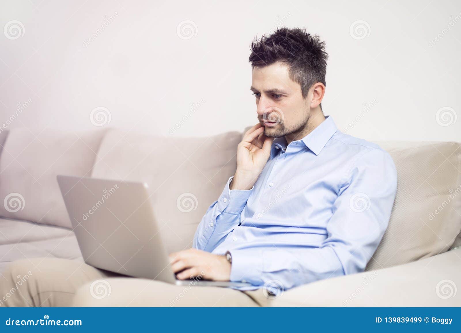 Upset and Worried Young Businessman Sitting and Working at Laptop Stock ... Upset and Worried Young Businessman Sitting and Working at Laptop Stock ...