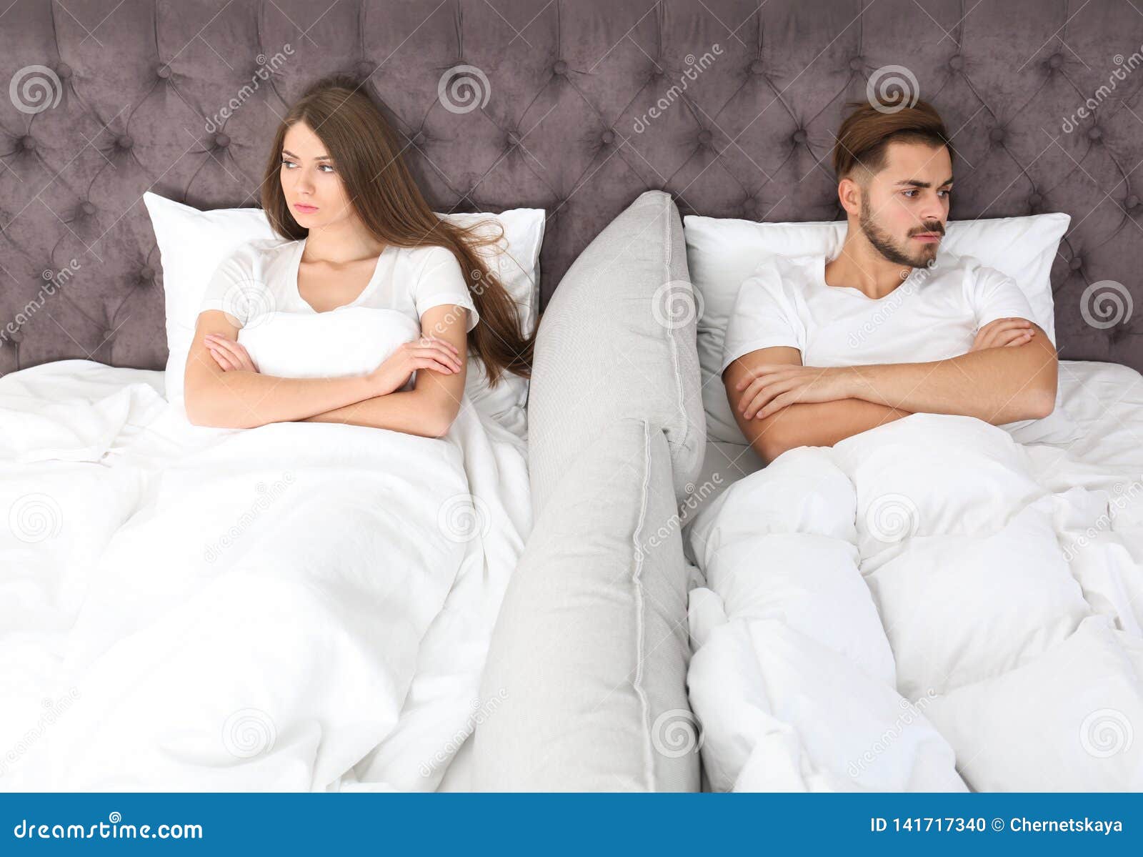 Upset Young Couple with Relationship Problems Lying Separately in Bed ...
