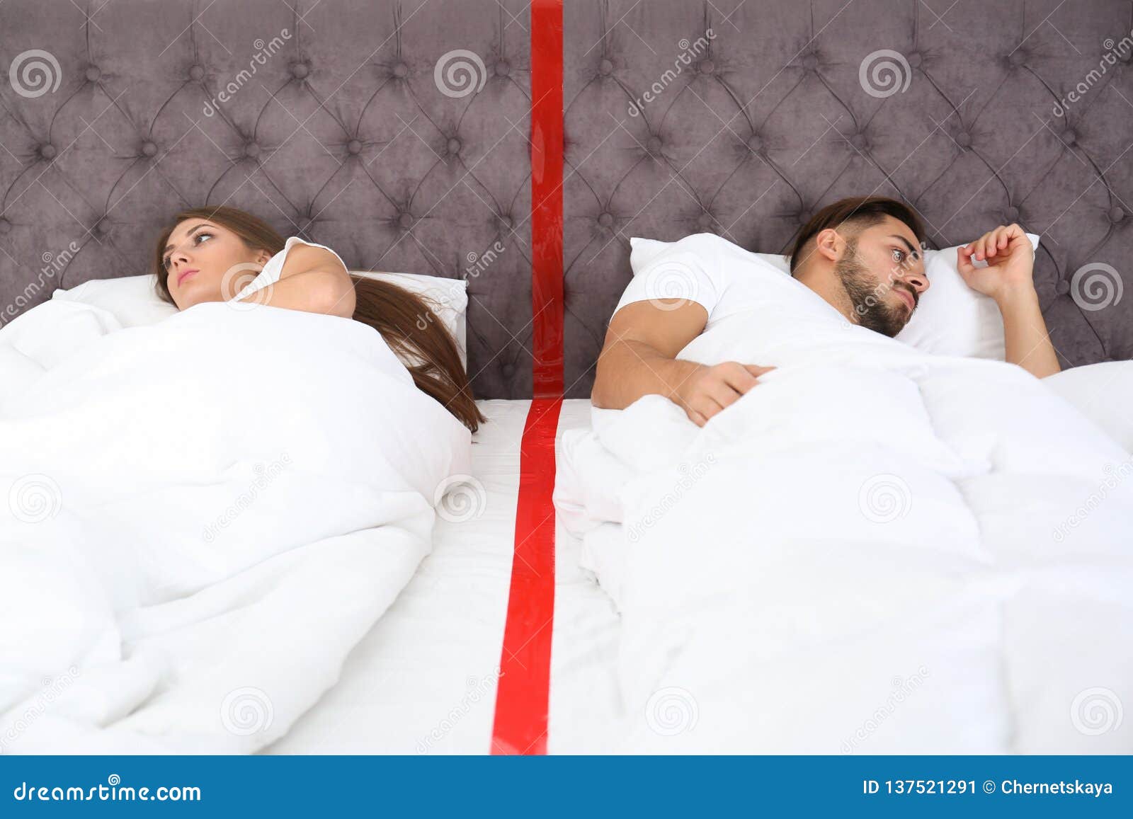 Upset Young Couple with Relationship Problems Lying Separately in Bed ...
