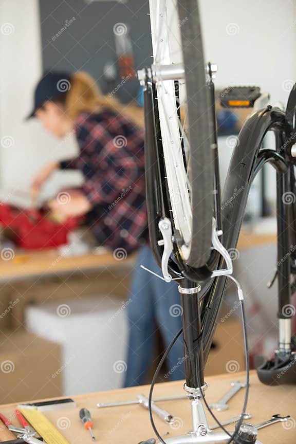 Upside-down Bicycle on Workbench Stock Image - Image of female, cyclist: 263004519