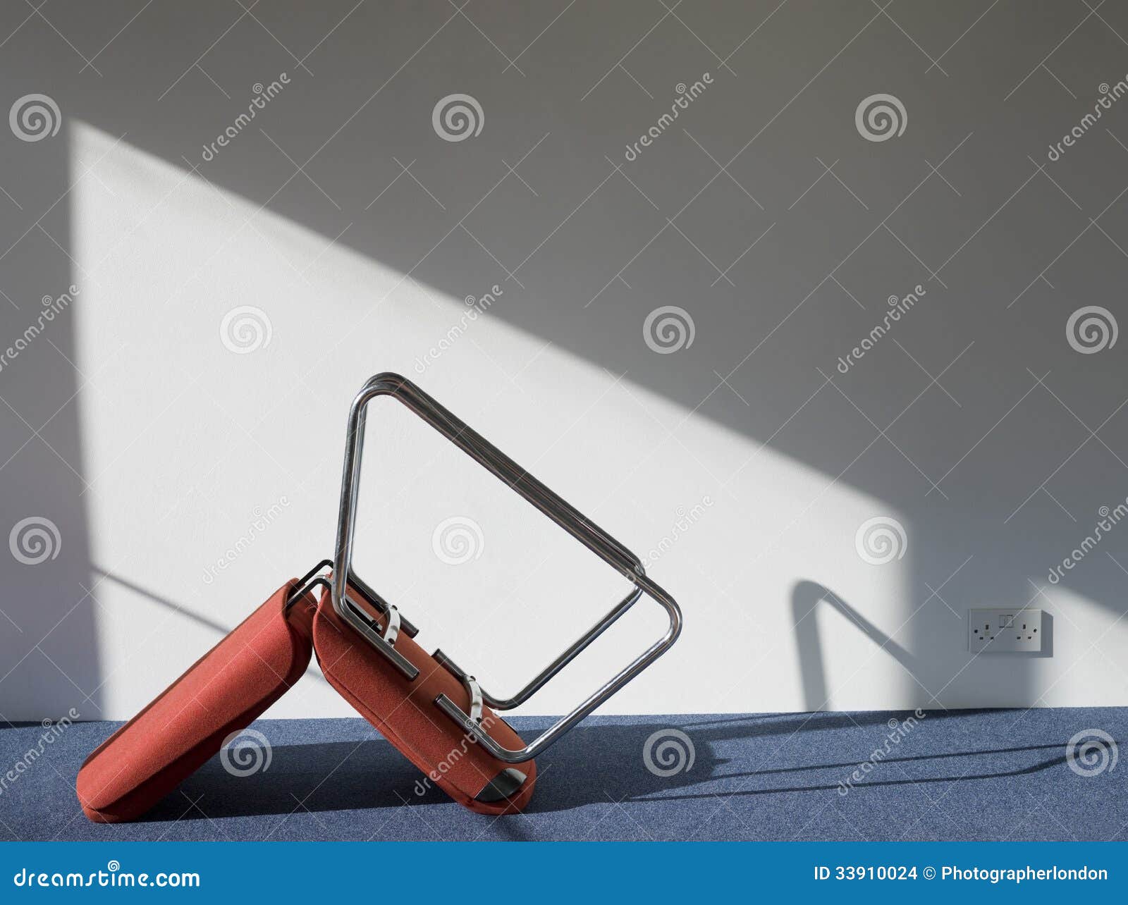Upturned Office Chair Casting Shadow on Wall Stock Photo - Image of ...