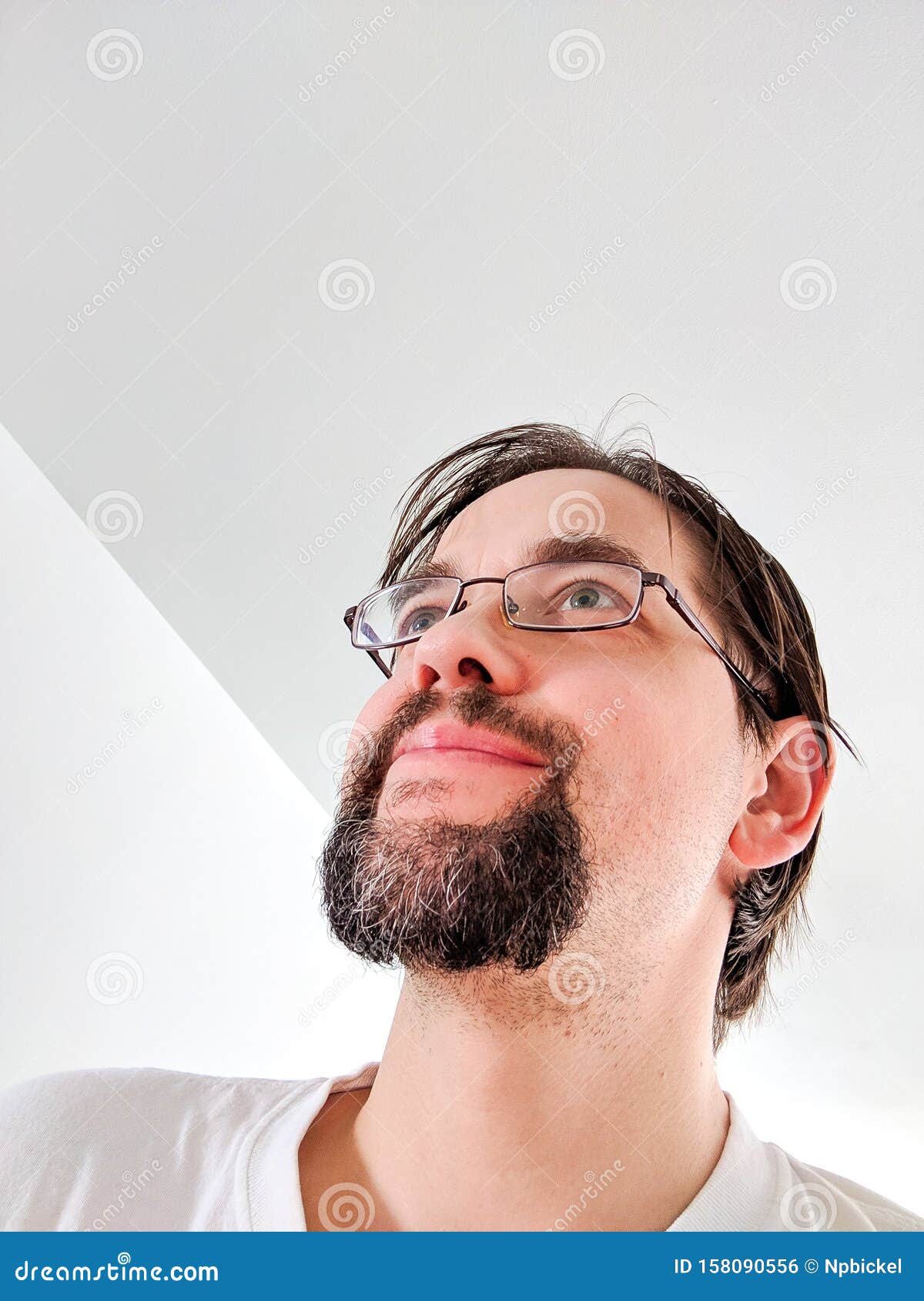 Upward Shot of Young Man Looking Forward with Determination Stock Photo ...