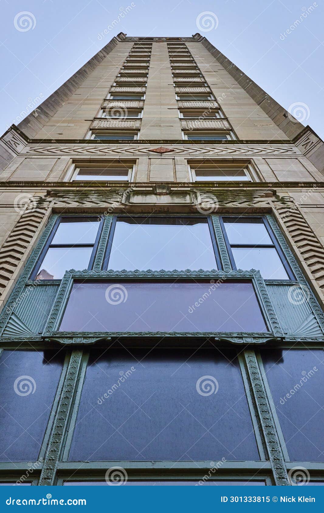 Upward View of Side of Skyscraper Building with Windows Reflecting Blue ...