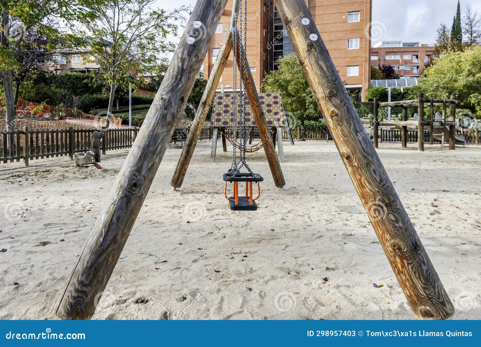 An Urban Playground with Swings and Slides on a Sandy Floor Stock Image ...