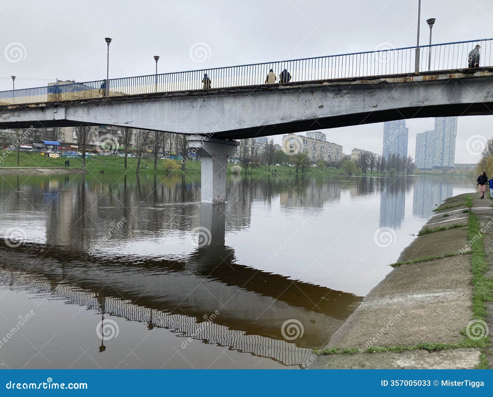 An Urban Riverfront Image with a Calm, Muddy or Silty River Reflecting ...