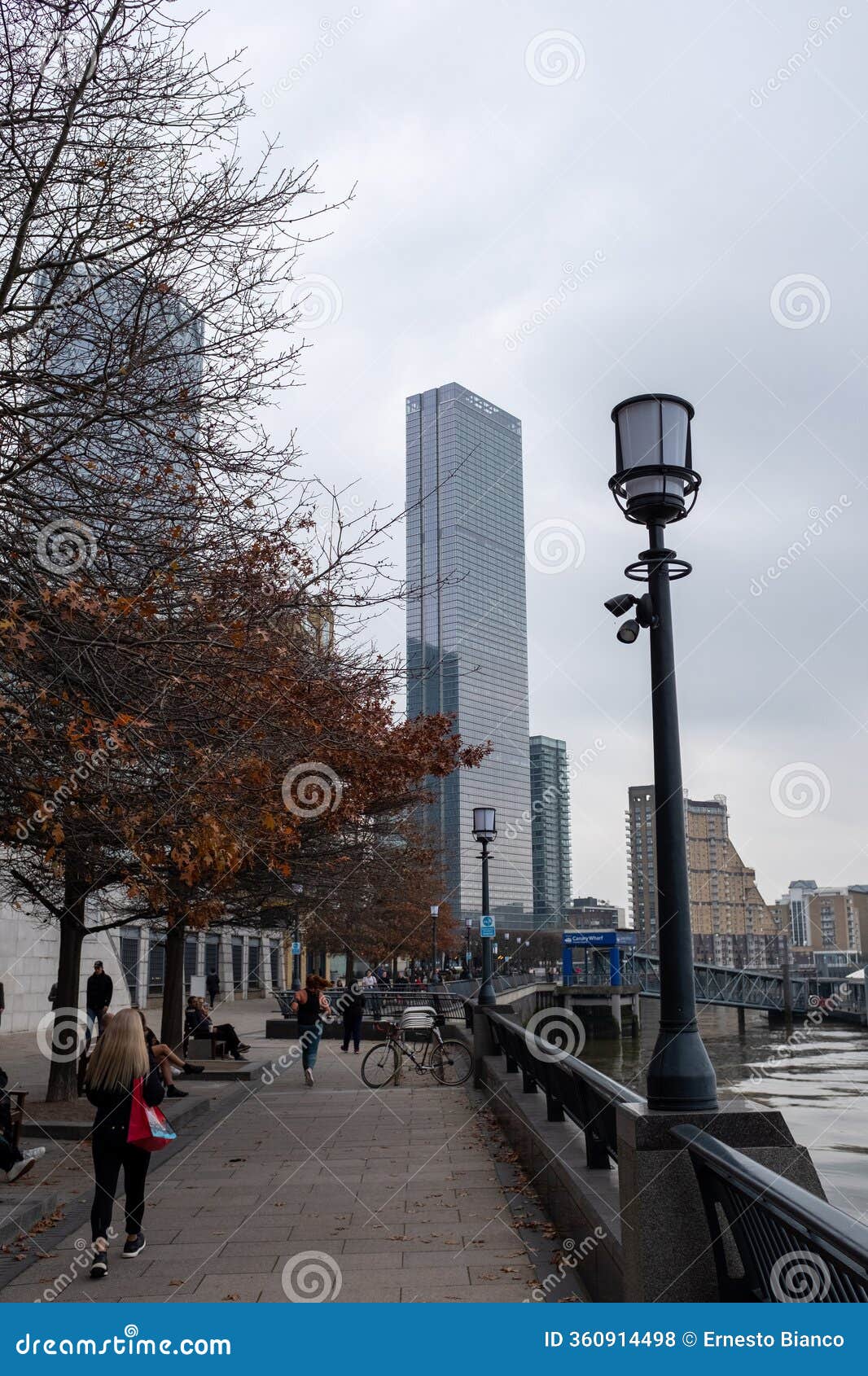 Urban Riverside Scene with a Tall Skyscraper Dominating the Skyline ...