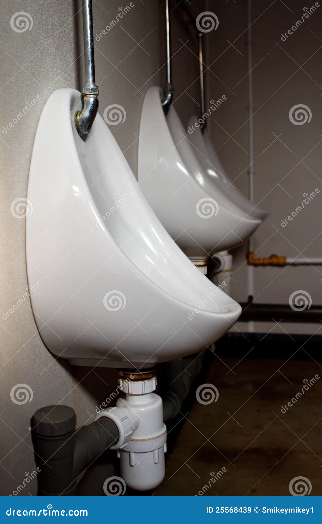 Three Urinals In The Men Public Restroom With Automatic Water Flushing ...