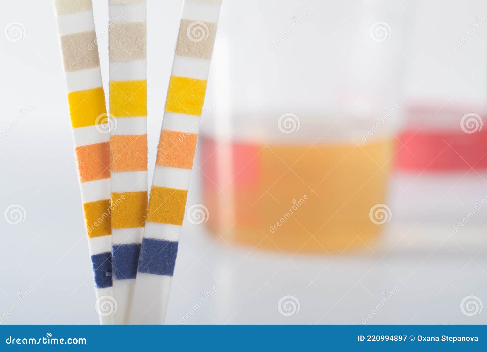 Urine Test Strip Against a Urine Sample on a White Background Vertical ...
