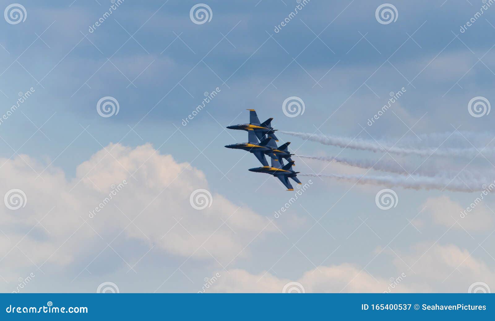 The US Navy Blue Angels Fly in Formation Across the Clouds in the Sky ...