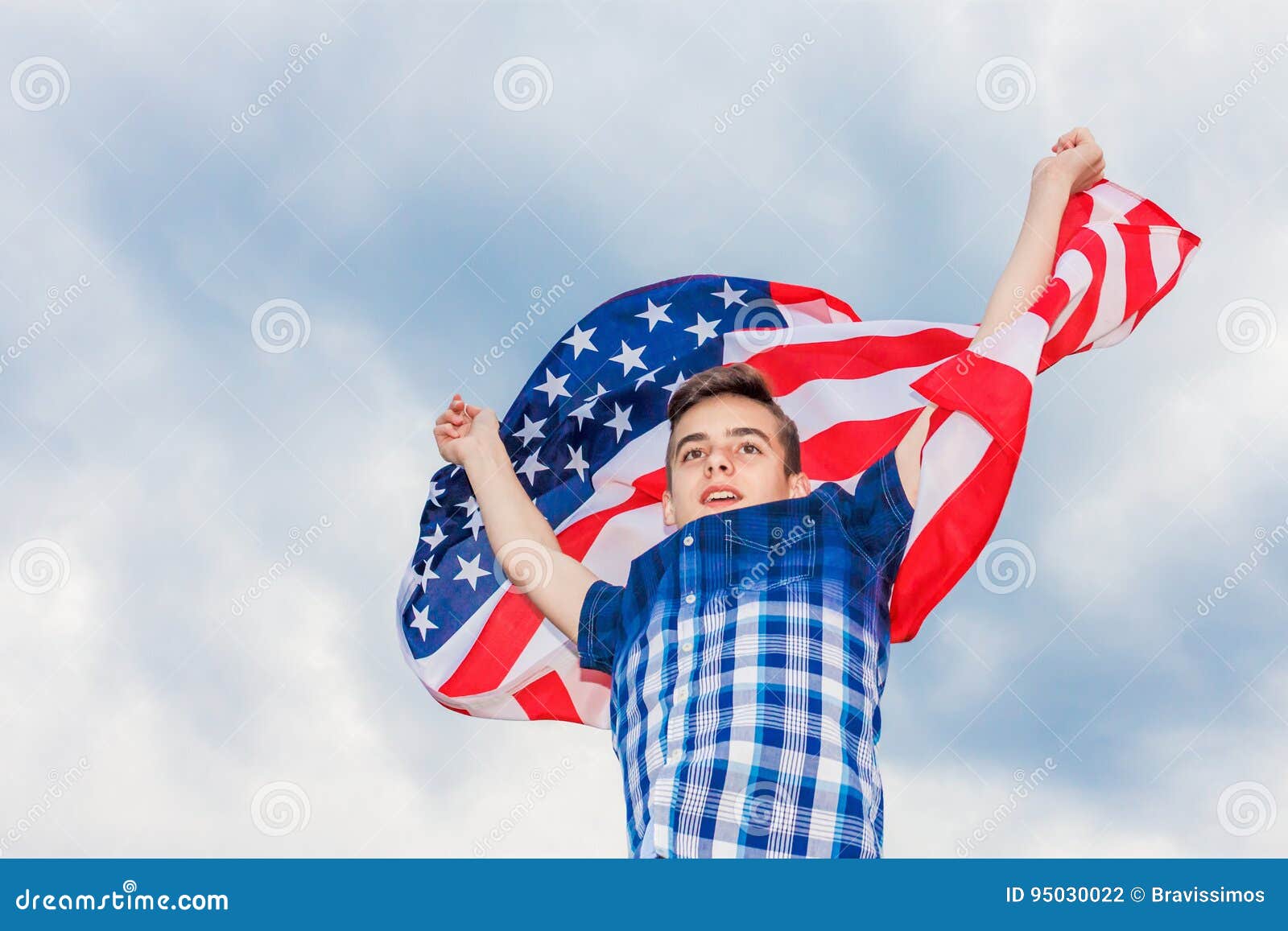 USA Flag is Held by a Running Guy in the Background of a Summer Sky ...