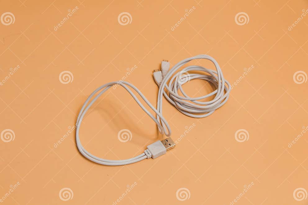 USB Cable for Smartphone on Beige Background, White Usb Cable on Beige ...