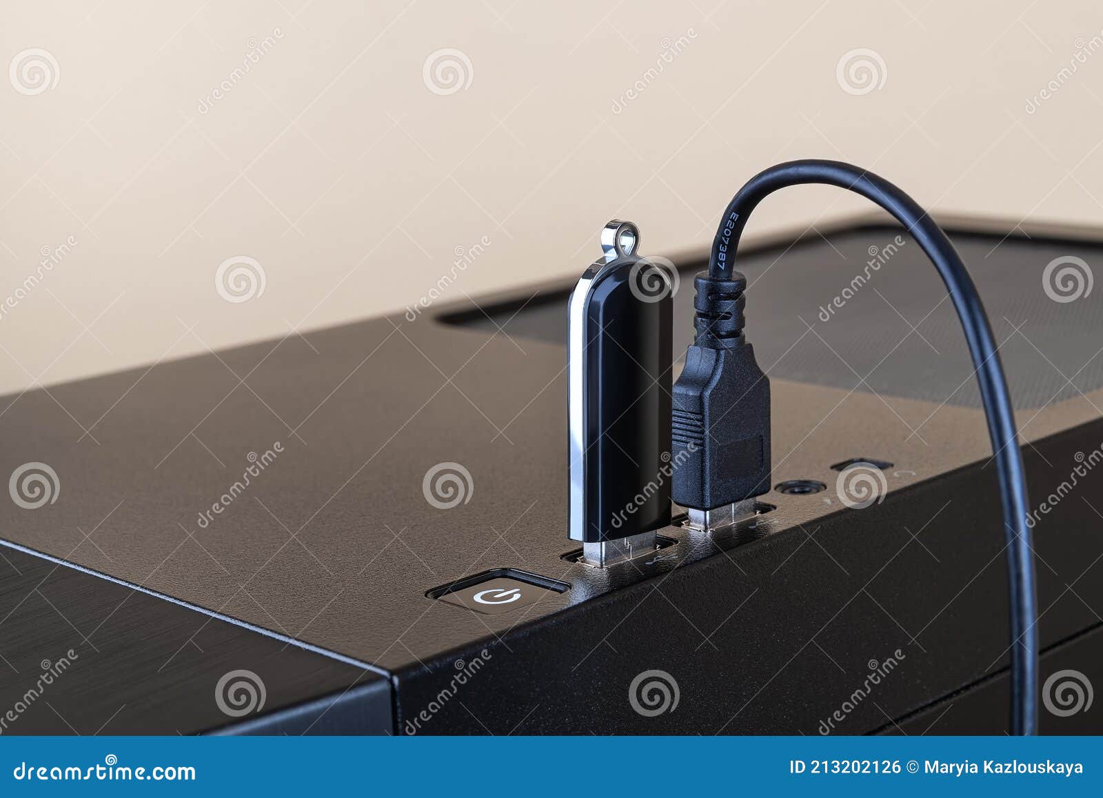 USB Flash Drive and USB Cable Both Inserted into Ports on the Top of a ...