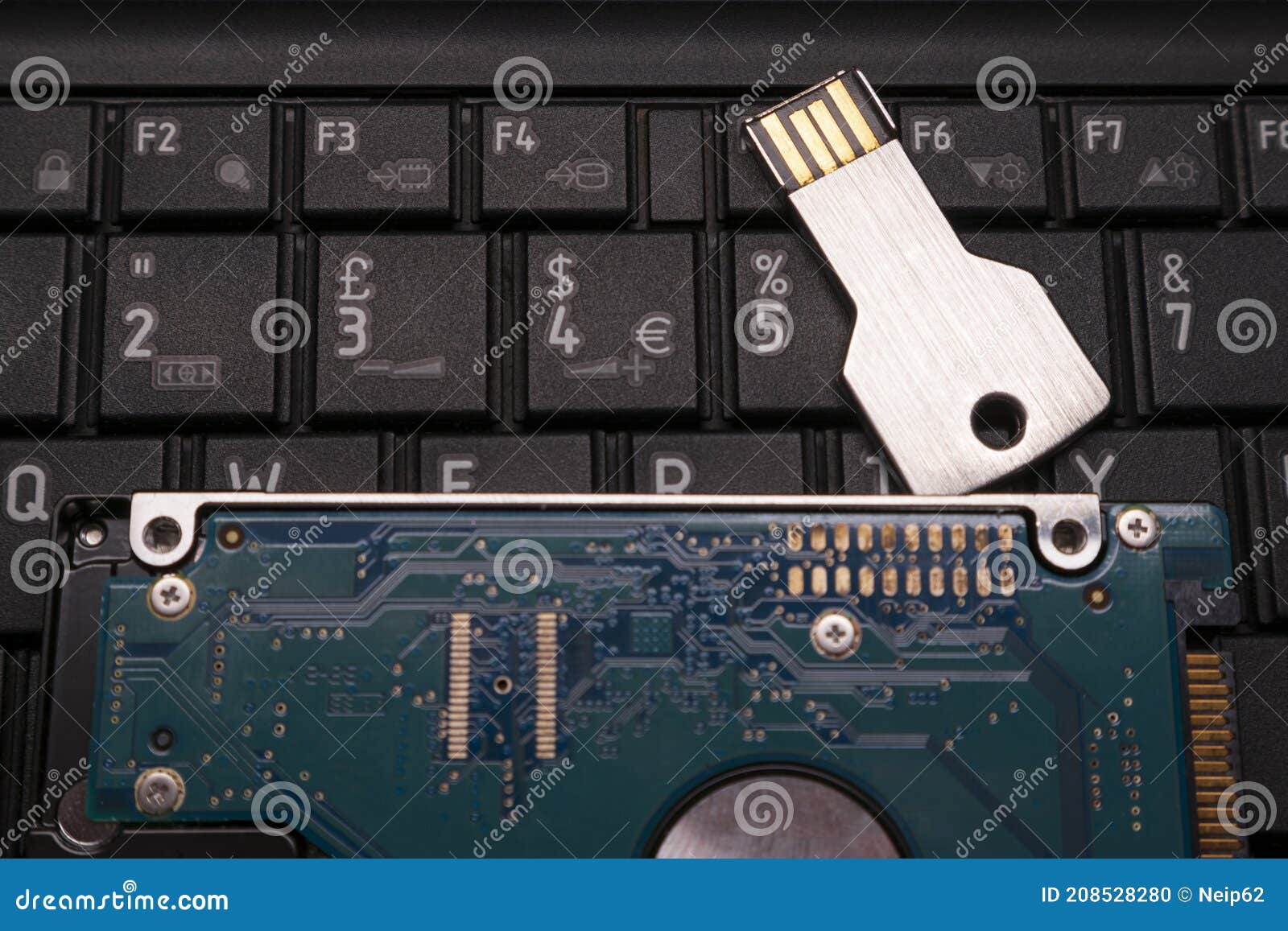USB Flash Drive in the Form of a Metal Key. Blurred Hard Disk and ...