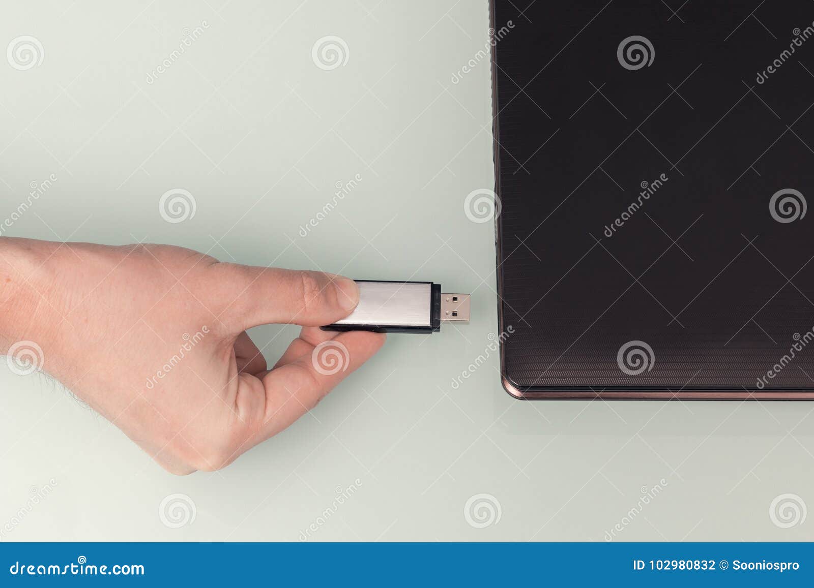 USB Metal Flash Memory on Hand with Notebook Computer Connected Stock ...