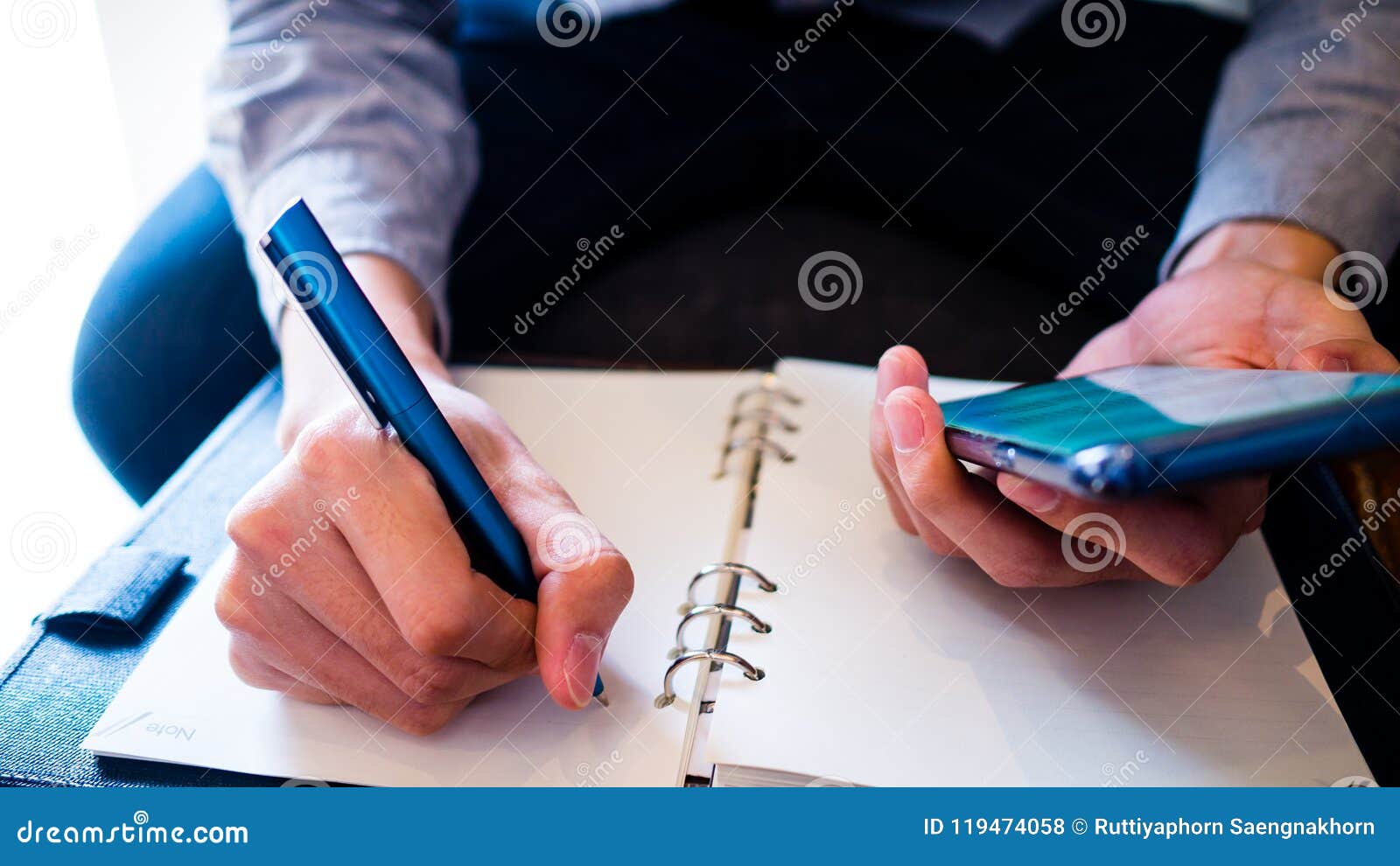 Use Smart Phone and Make a Note in Note Book Stock Photo - Image of ...