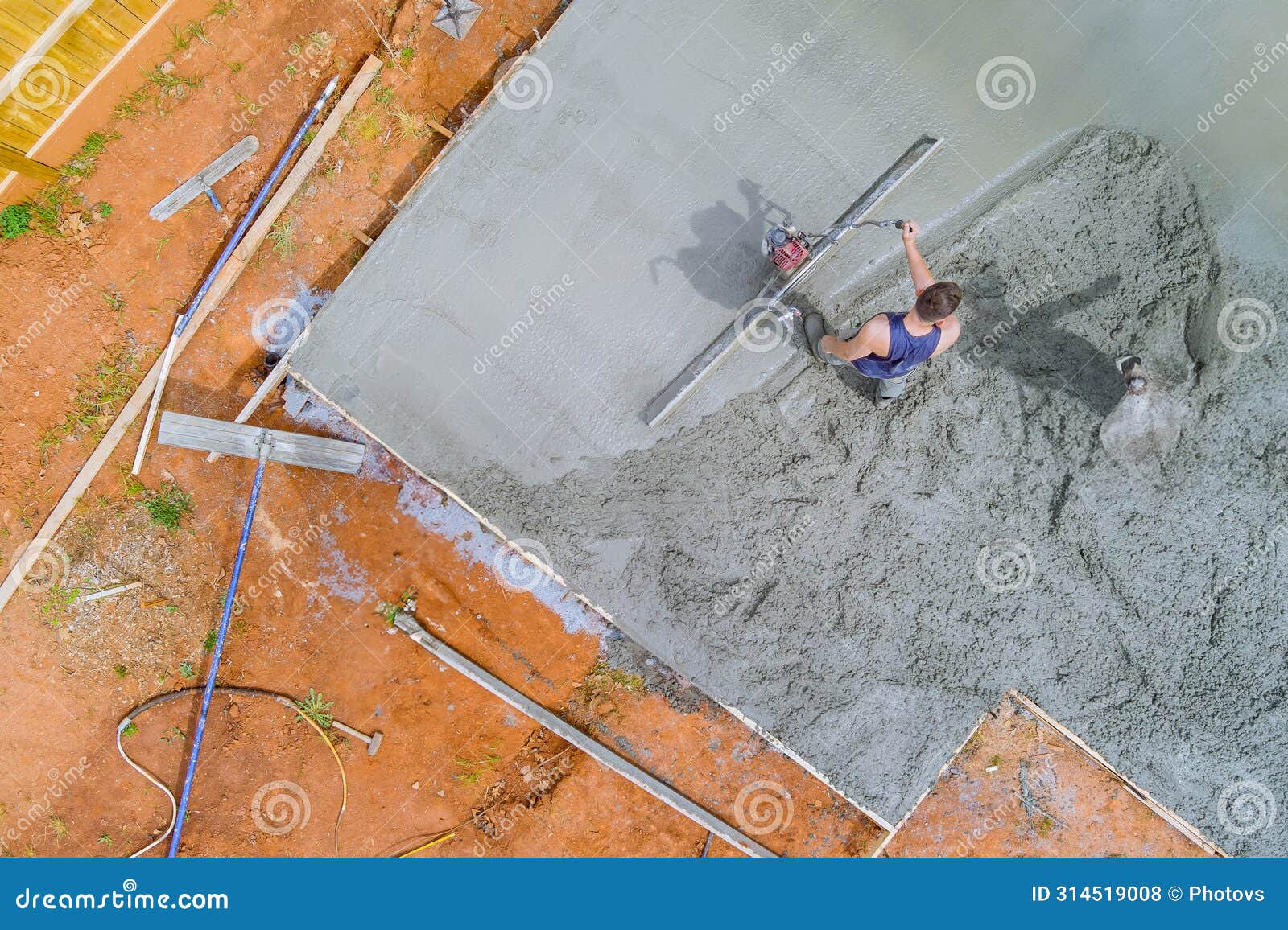 Use of Special Tools by a Construction Worker in Leveling Concrete ...