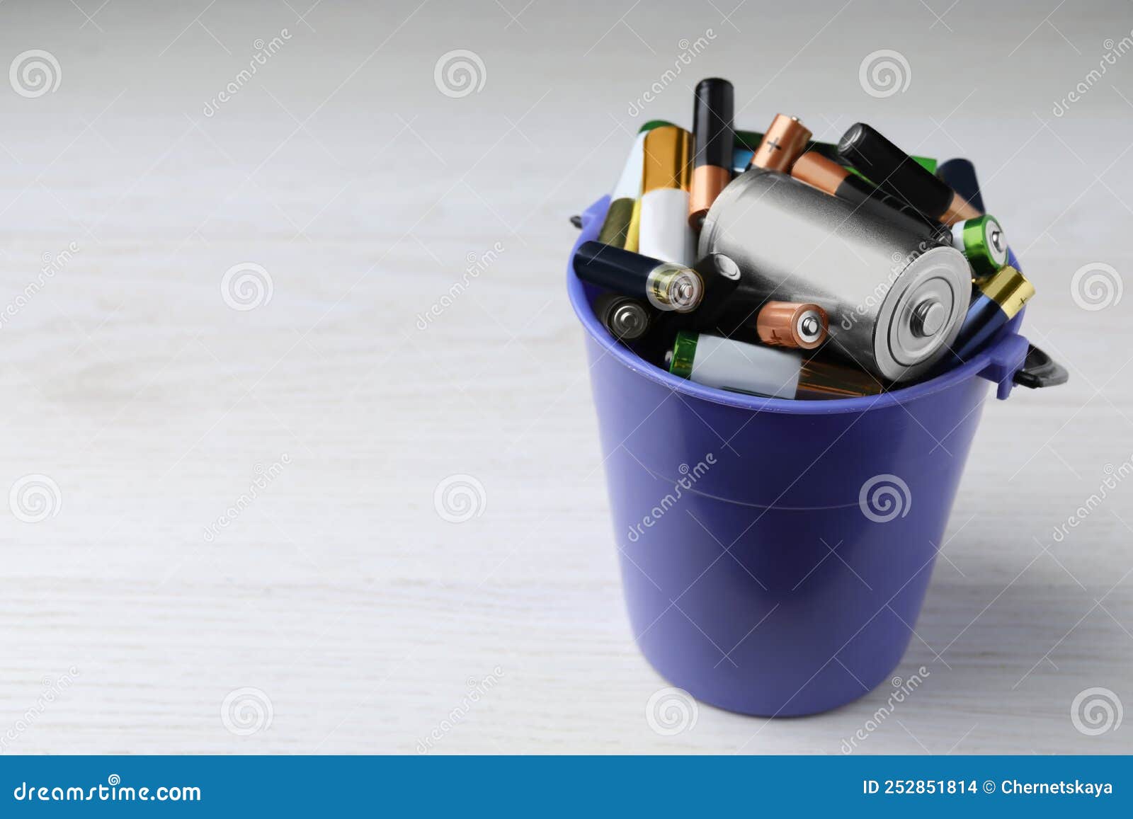 Used Batteries in Bucket on White Table, Space for Text Stock Photo ...