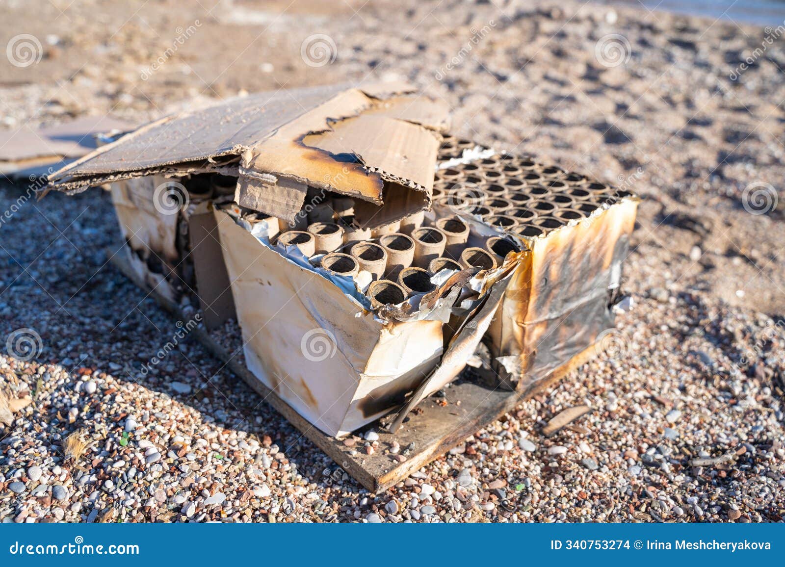 Spent Firework Box on Pebble Beach Stock Photo - Image of pebble ...