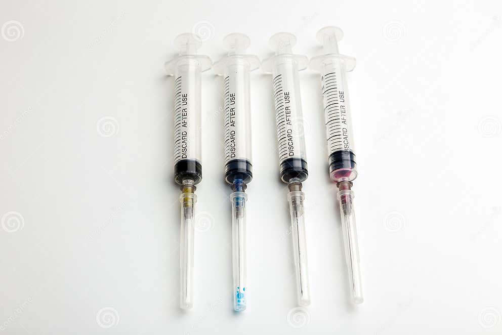 Used Syringes with a Protective Cap on the Needle with Colored ...