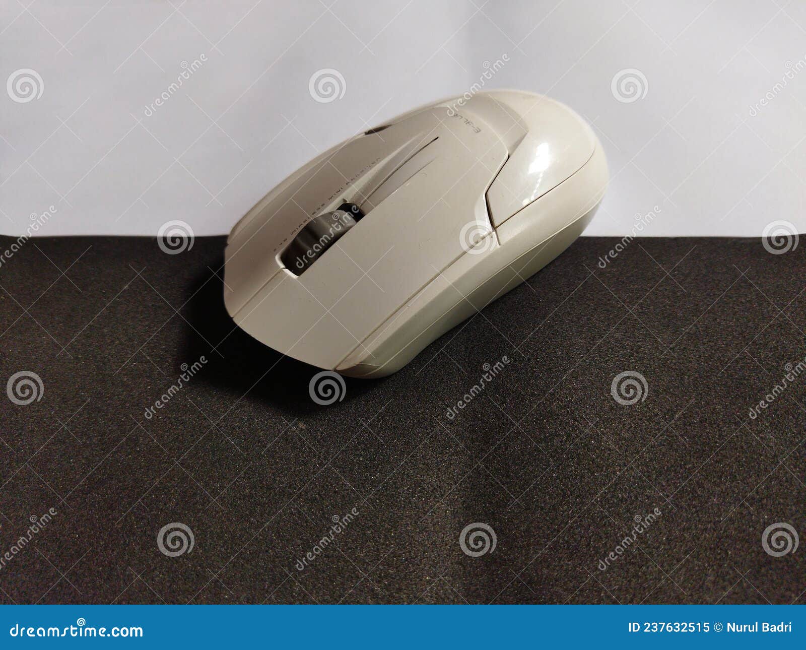 A Used White Wireless or Bluetooth Mouse on a Black and White ...
