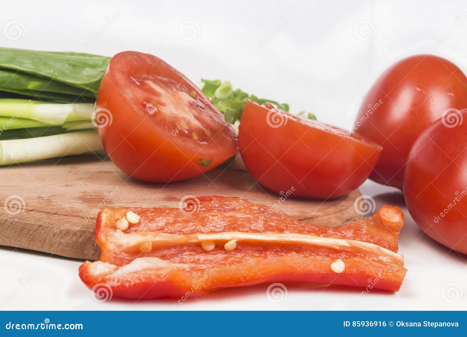 Useful Sliced Tomatoes on a Cutting Board with Red Pepper and Gr Stock ...